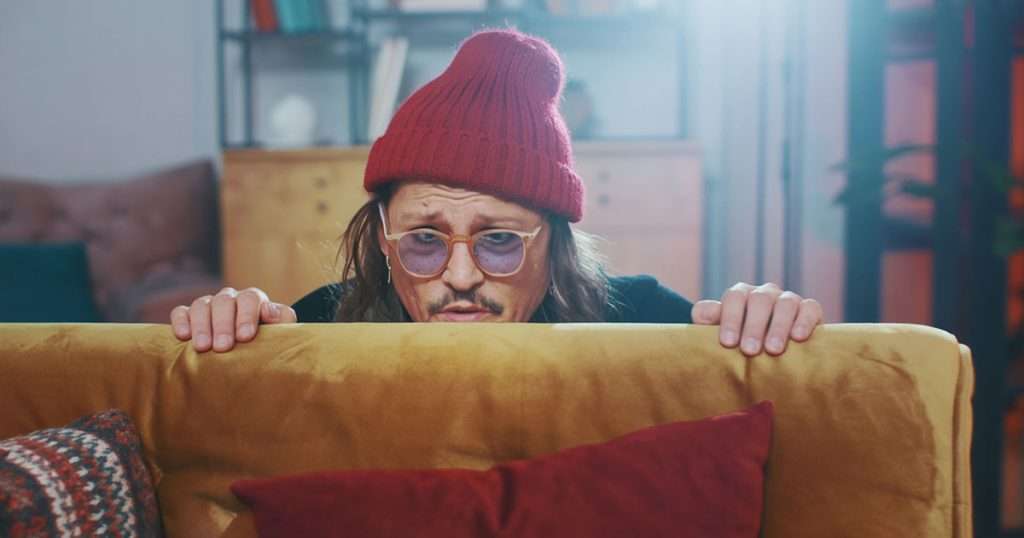 johnny depp hiding behind sofa